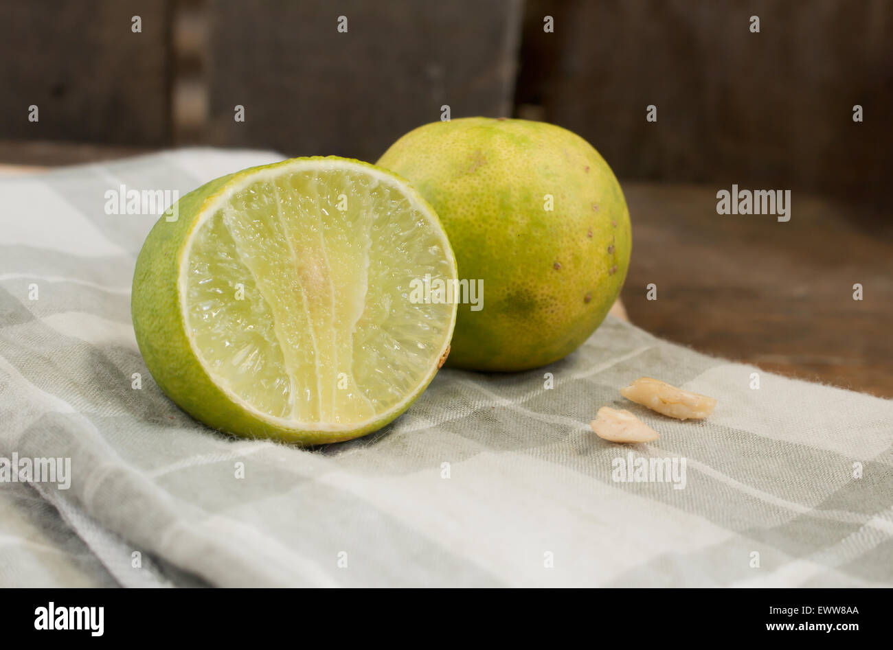 Two limes and cashew on handkerchief prepared to cook focusing on ...