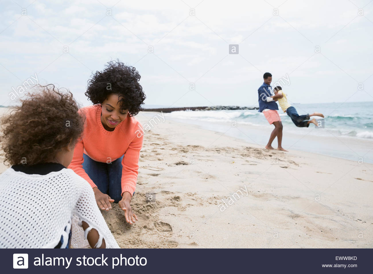 Family playing outdoors beach summer hi-res stock photography and ...