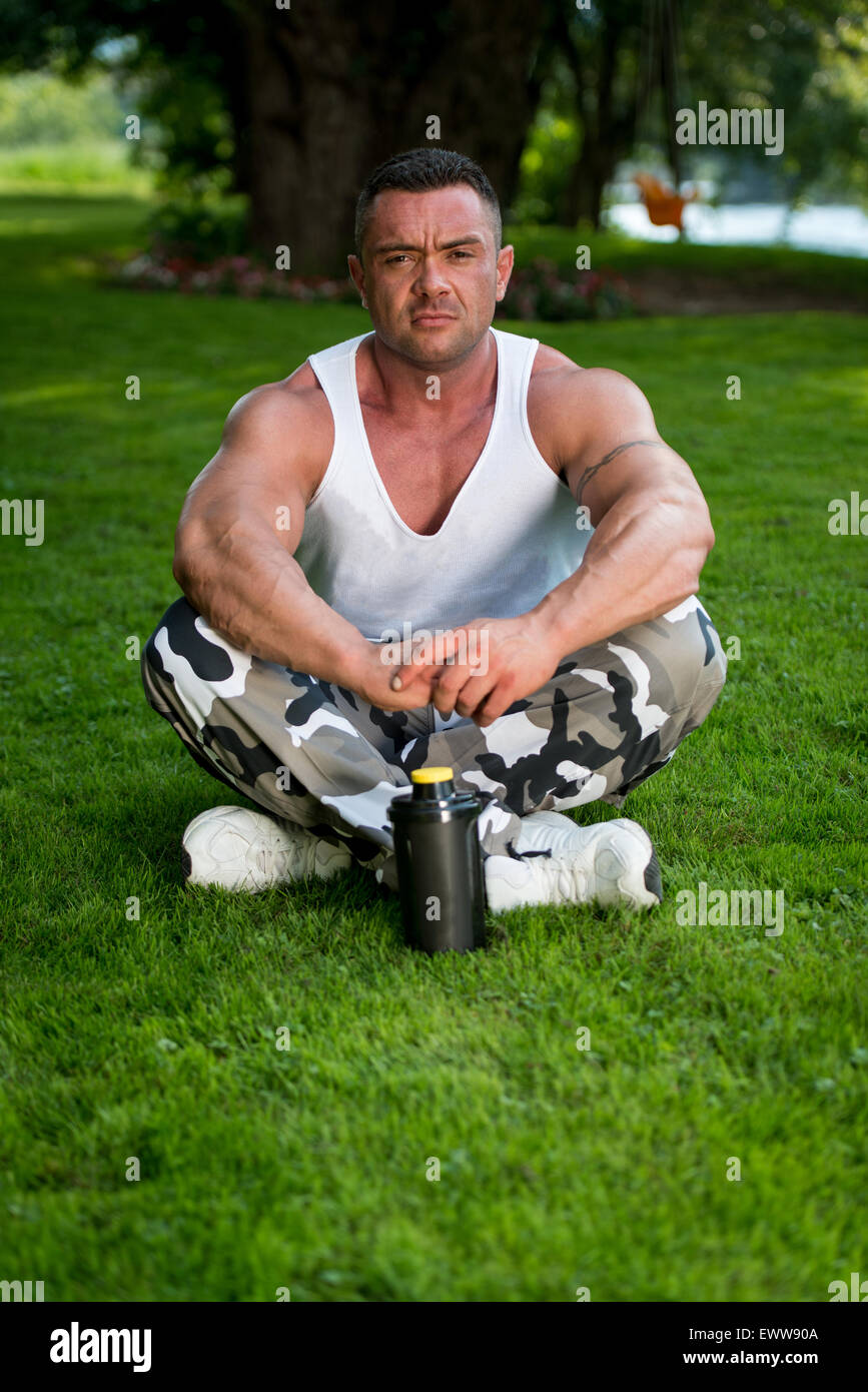 Bodybuilder Resting In Nature Stock Photo - Alamy