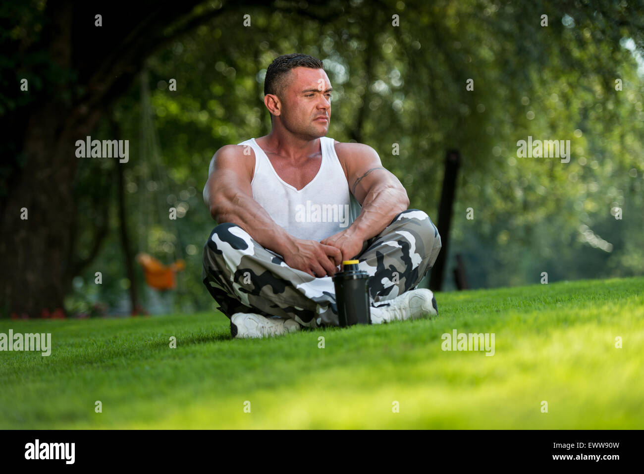 Bodybuilder Resting In Nature Stock Photo - Alamy