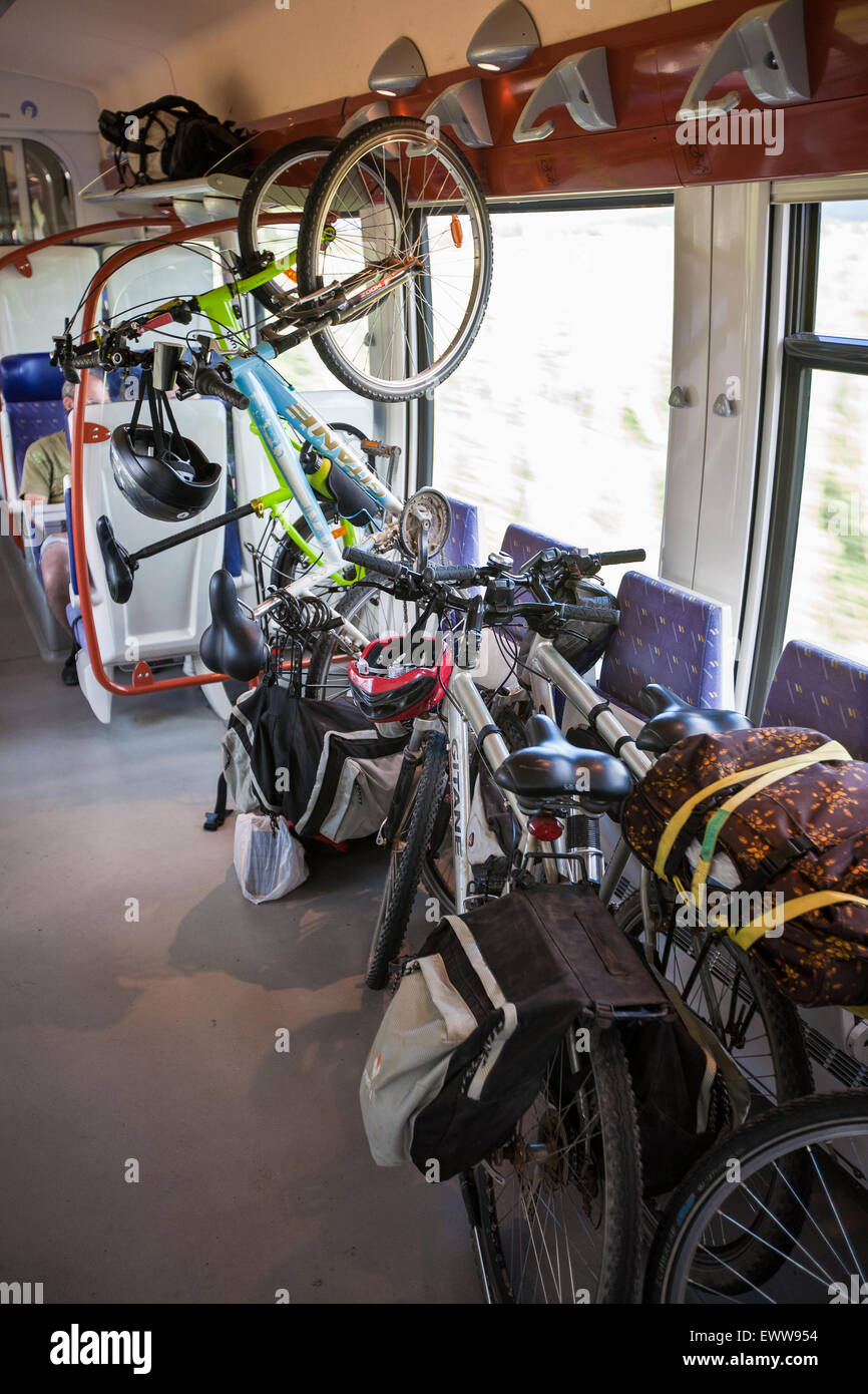 Bicycles hanging up on rack in bicycle area of local train in southern ...