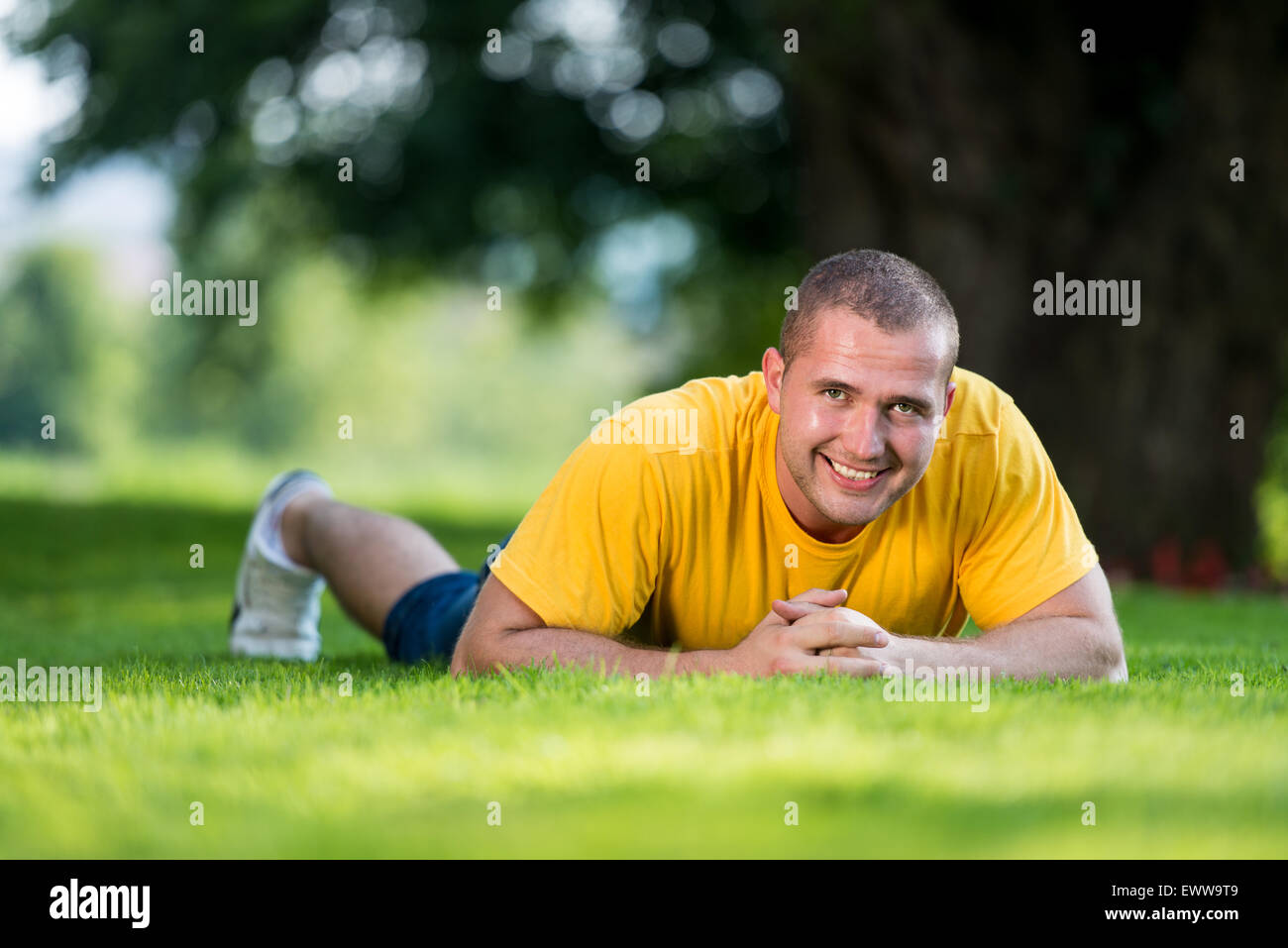 Men Resting In Meadow Stock Photo - Alamy