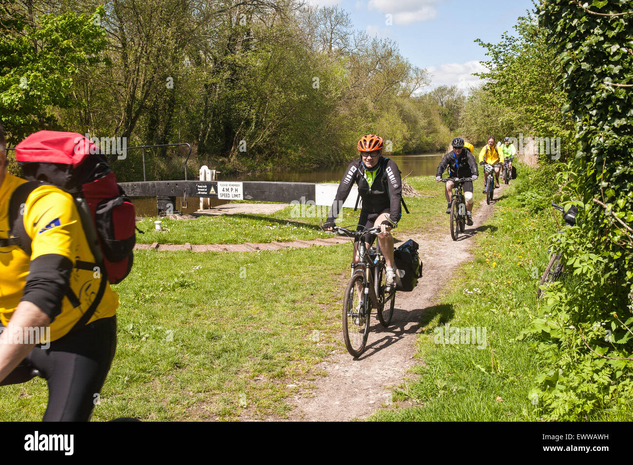 Lock, barrier and canal path used by cyclists and walkers. Group of ...
