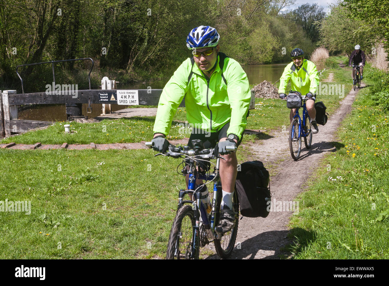 Lock, barrier and canal path used by cyclists and walkers. Group of ...