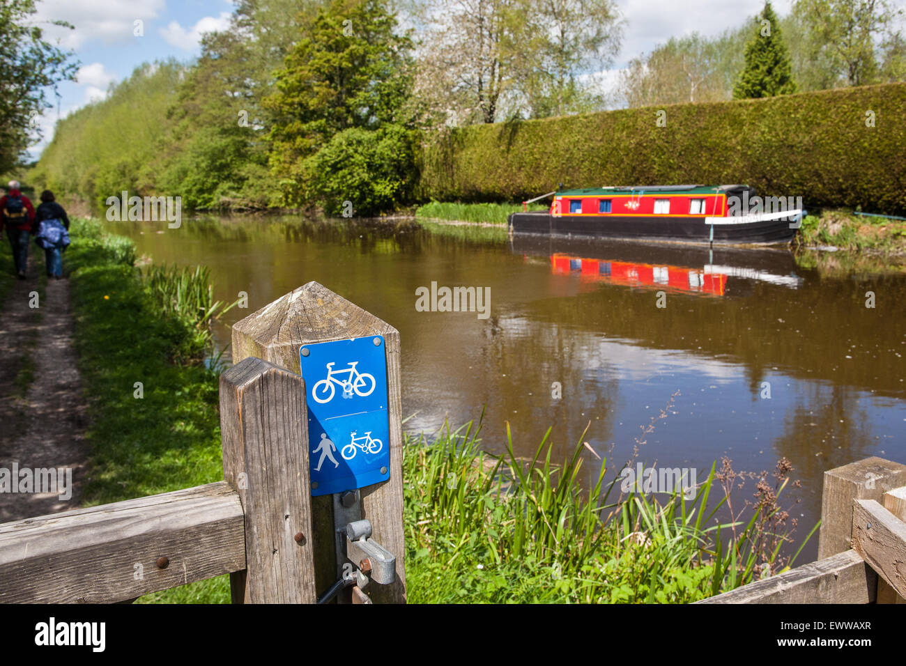 Canal path used by cyclists and walkers. Here hikers walking along path ...
