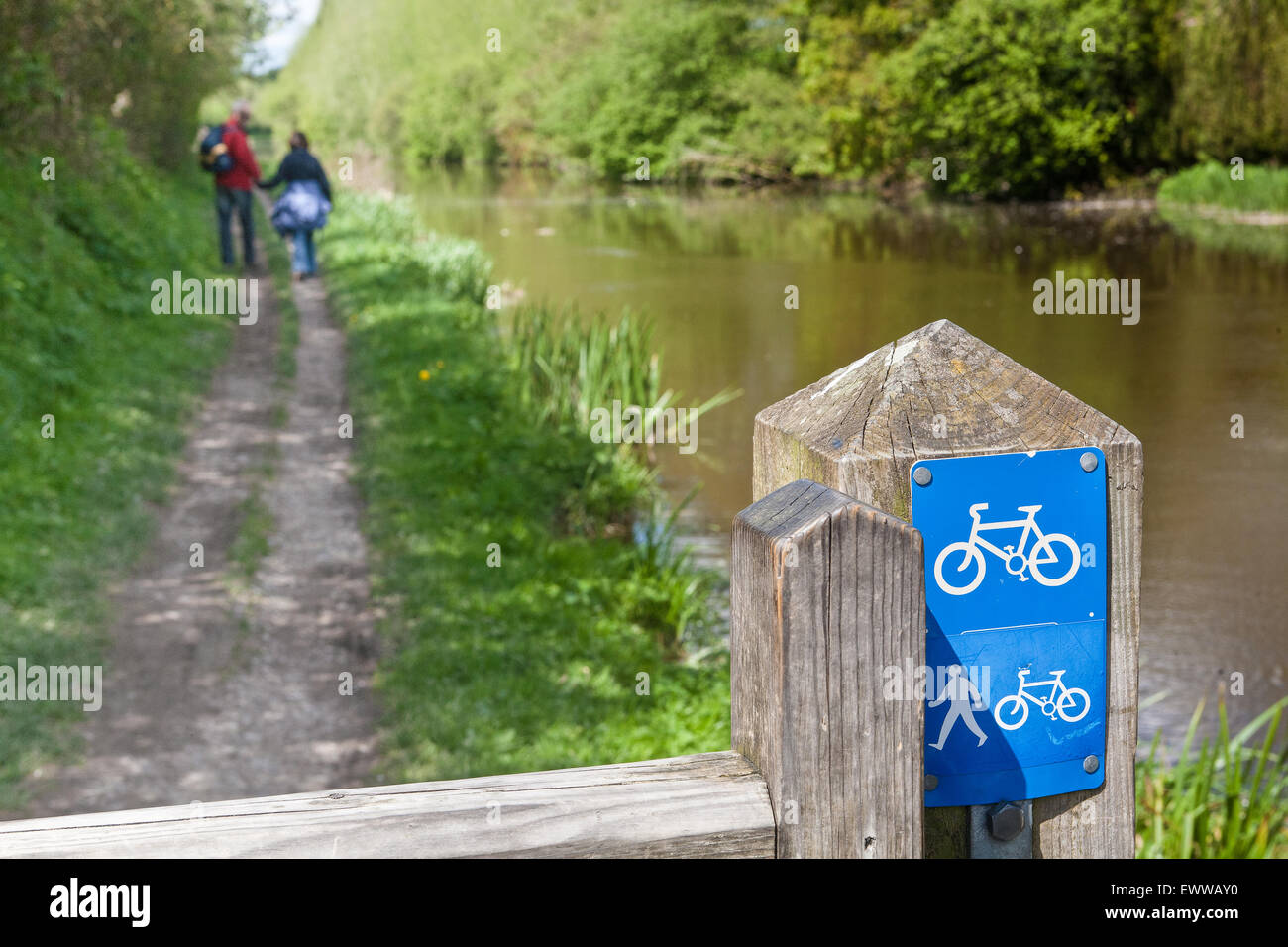 Canal path used by cyclists and walkers. Here hikers walking along path ...