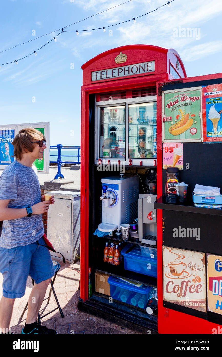 A Man Serves Ice Cream From A Converted Old Red Telephone Box ...