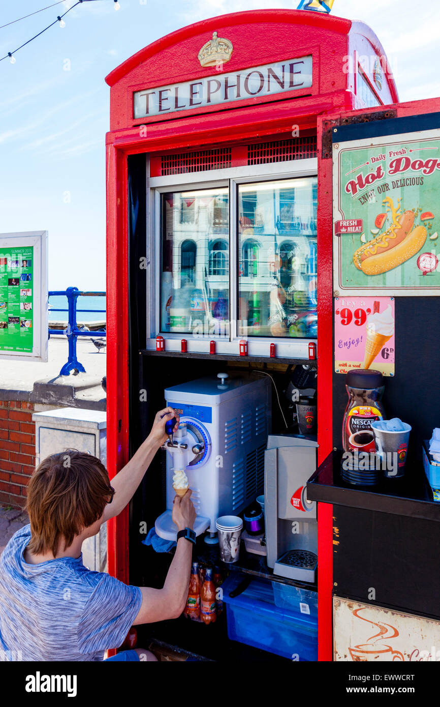 A Man Serves Ice Cream From A Converted Old Red Telephone Box ...