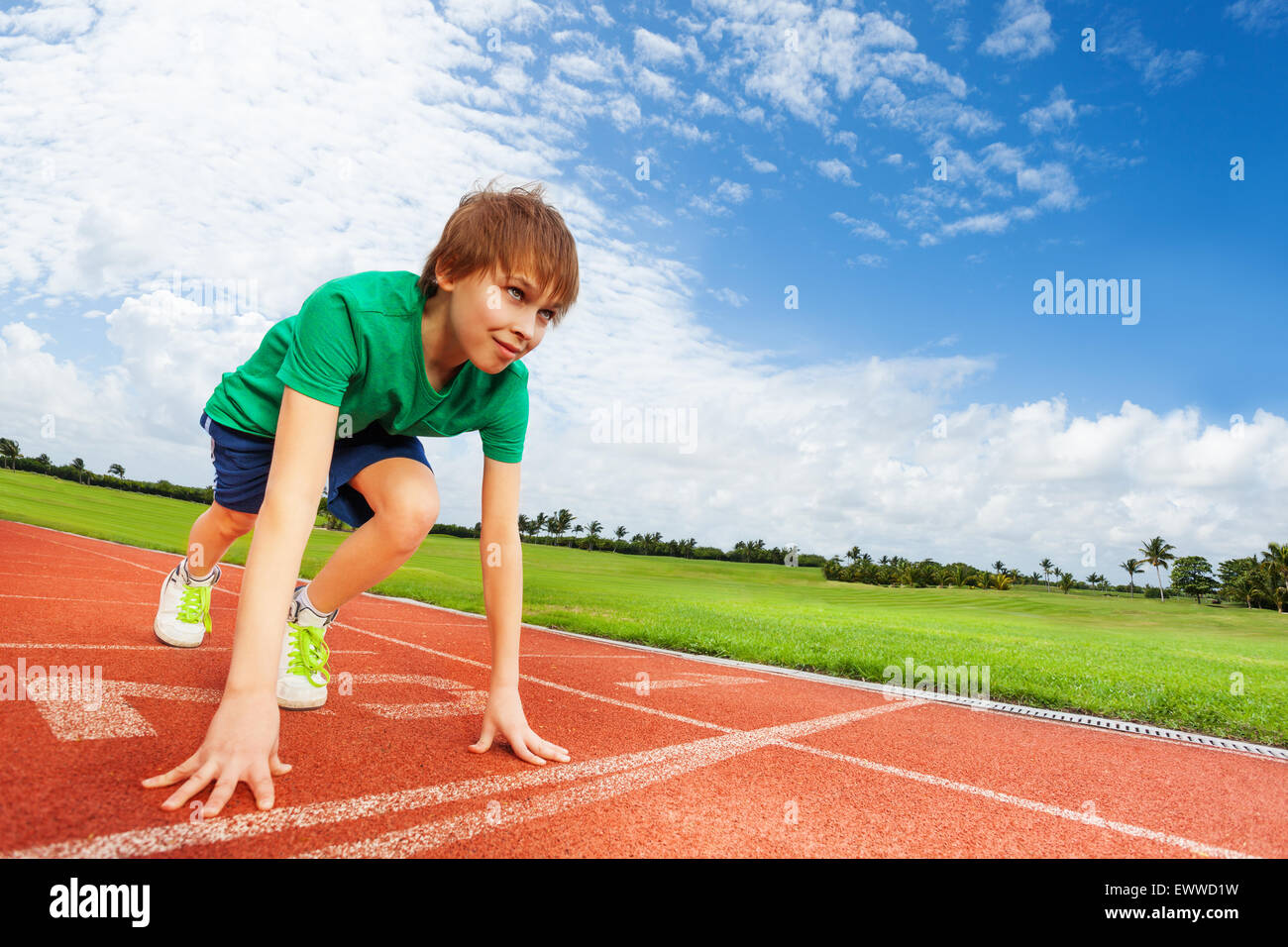 Boy in colorful uniform on the start ready to run Stock Photo - Alamy