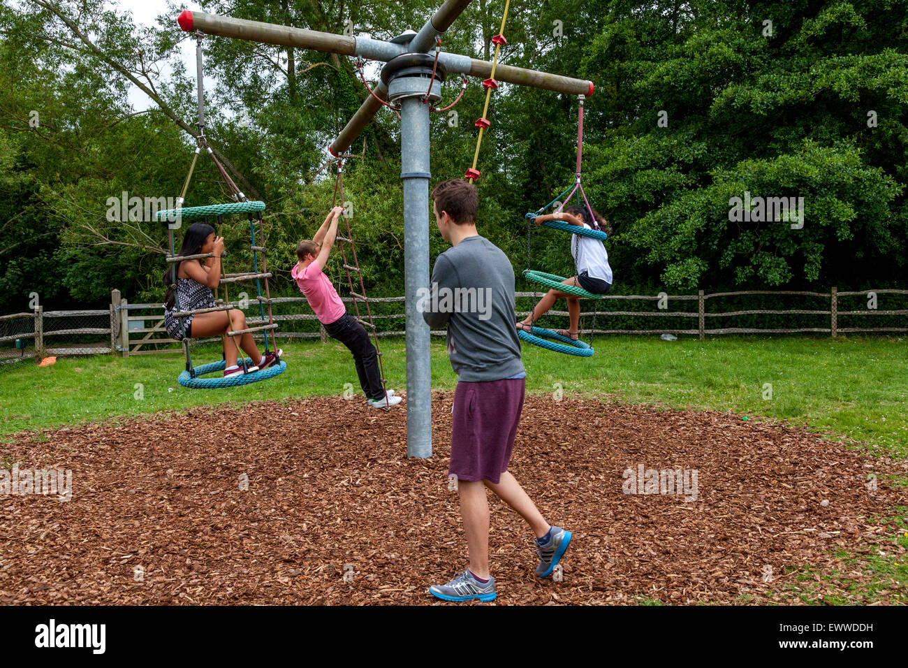 A Family Playing On The Swings, Play Area, Sussex, UK Stock Photo - Alamy