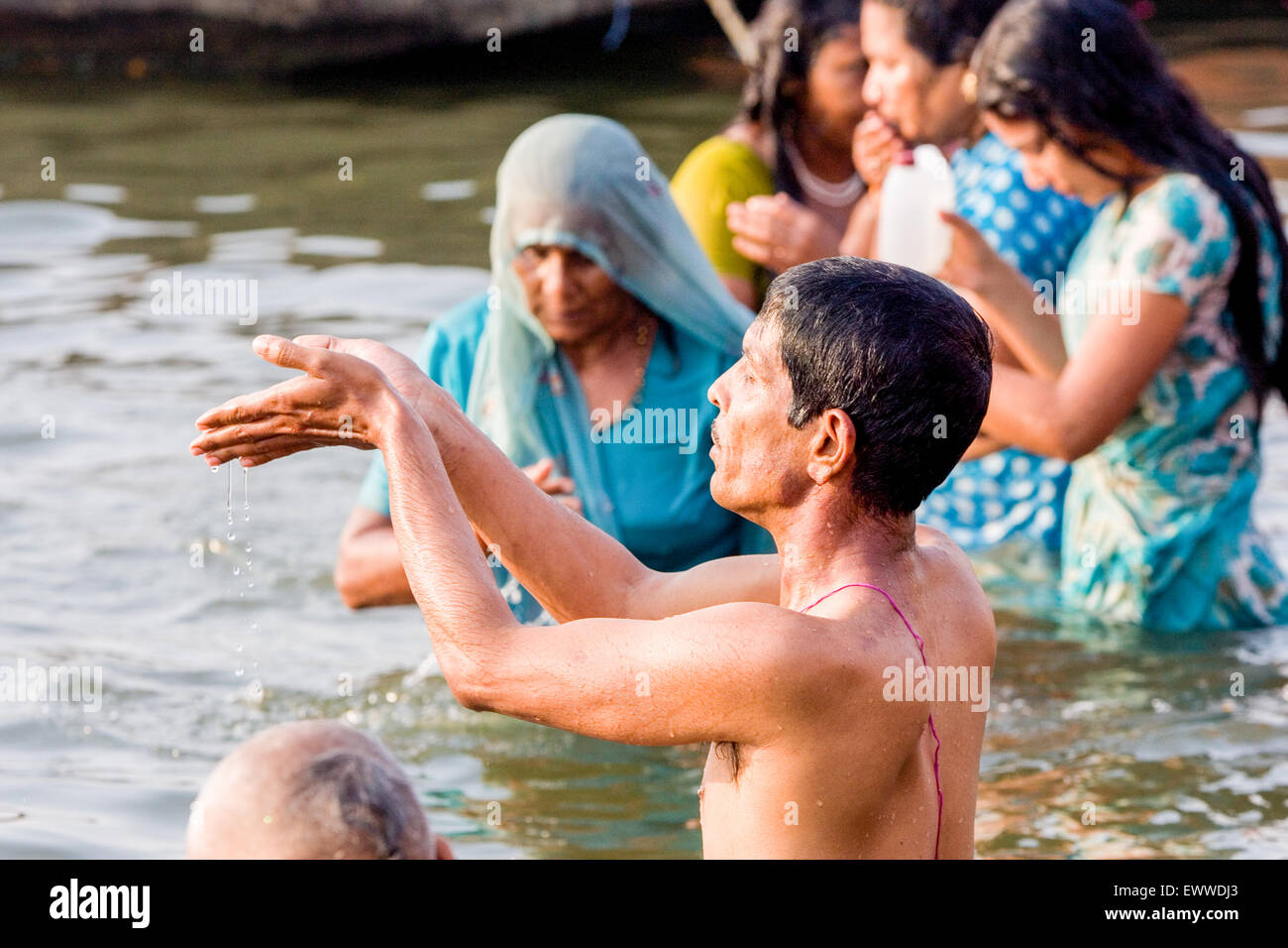 Hindus actually in the Ganges waters immersing themselves and offering ...