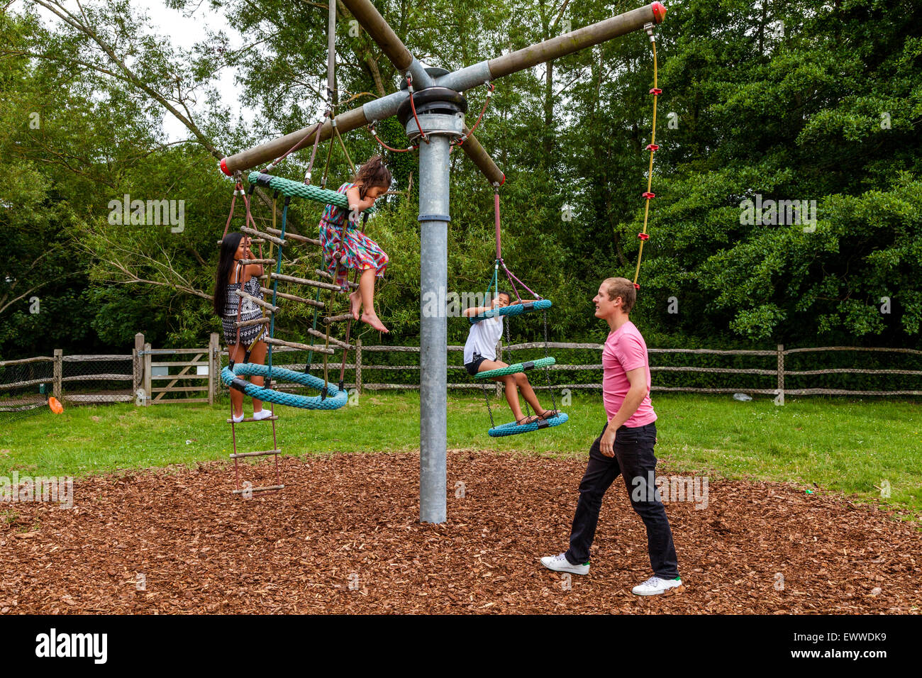 A Family Playing On The Swings, Play Area, Sussex, UK Stock Photo - Alamy