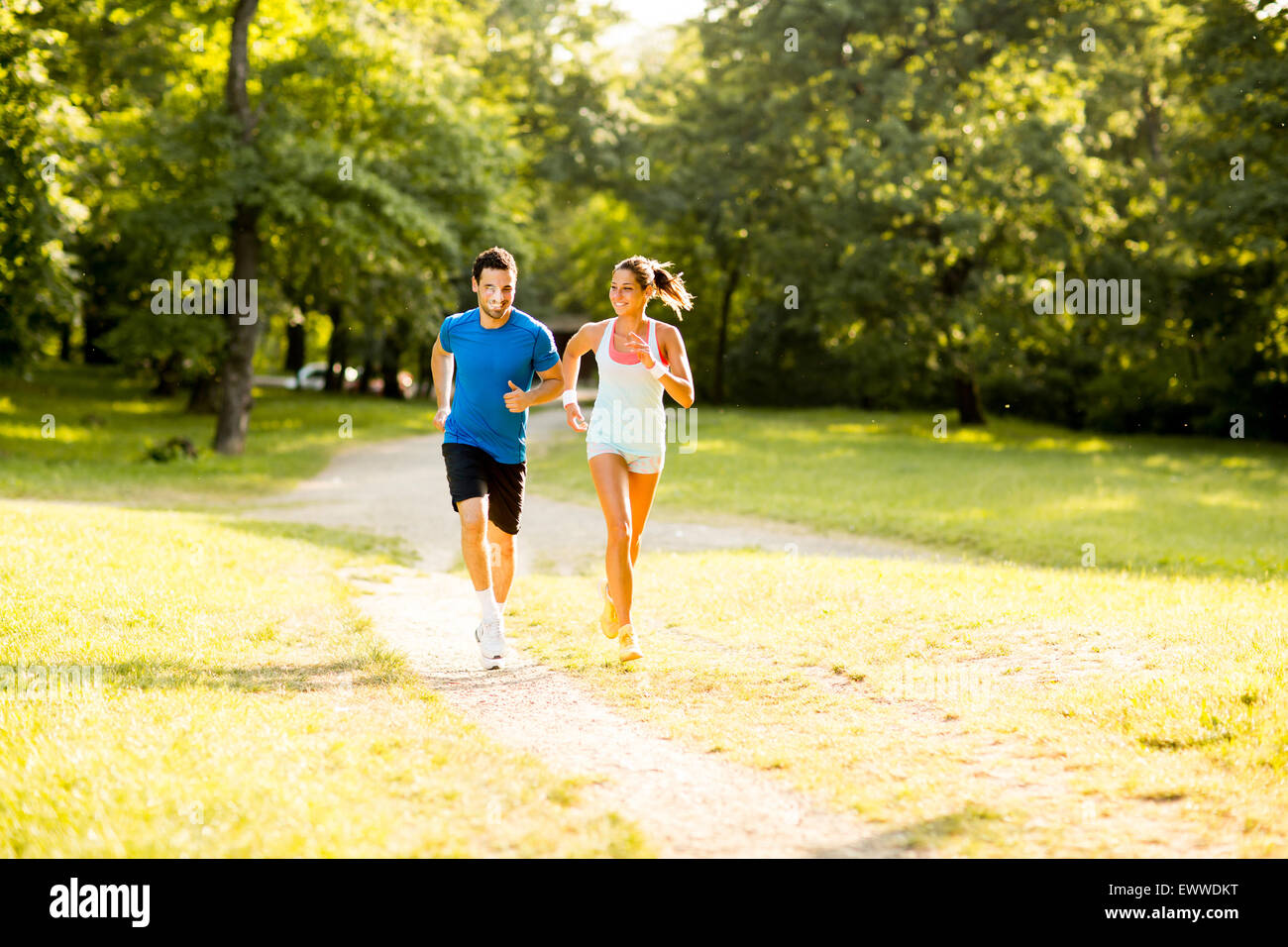 Young couple running Stock Photo - Alamy