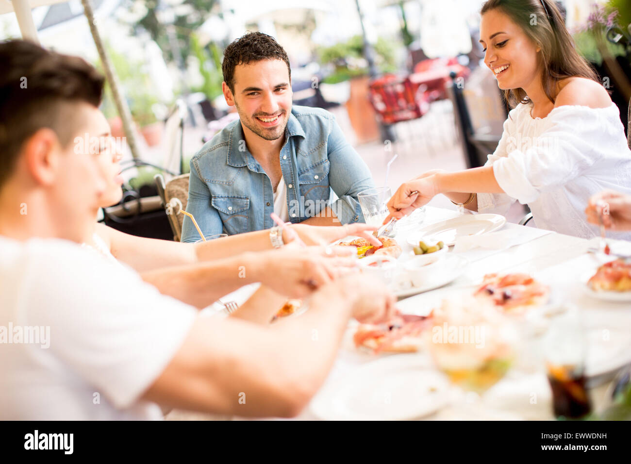 Young people by the table Stock Photo - Alamy