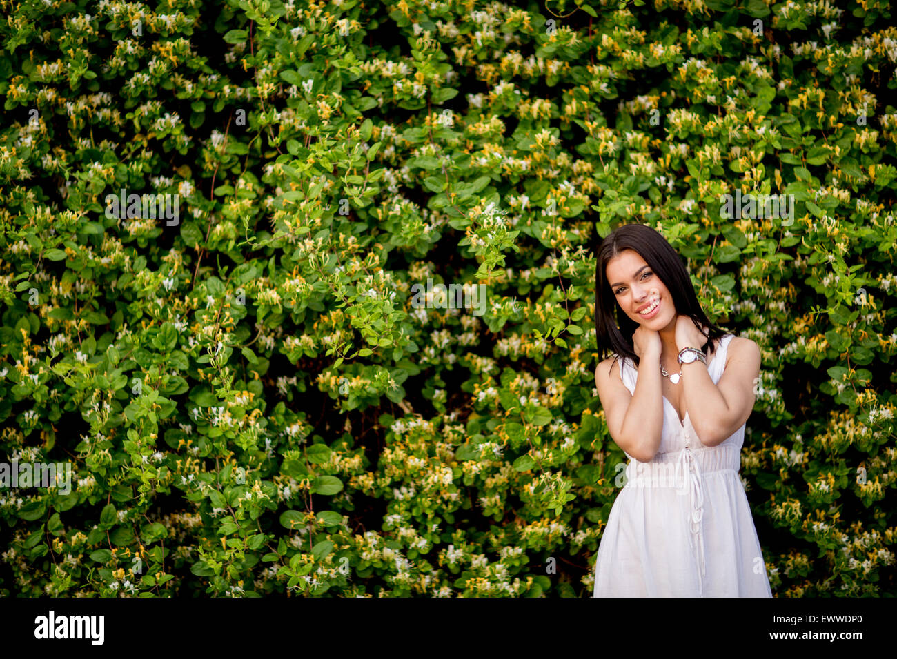 Young woman by the wall Stock Photo - Alamy