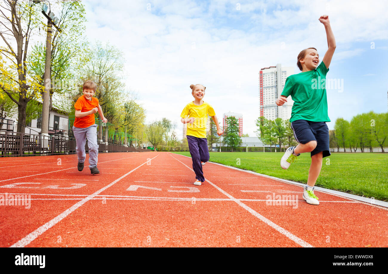 Boys and girl in colorful uniforms run marathon Stock Photo - Alamy