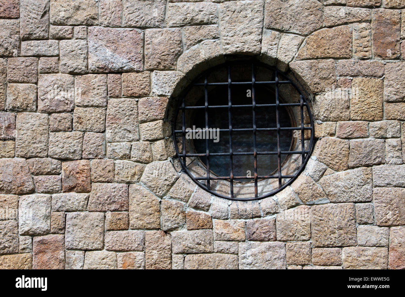 Round window on a stone wall Stock Photo - Alamy