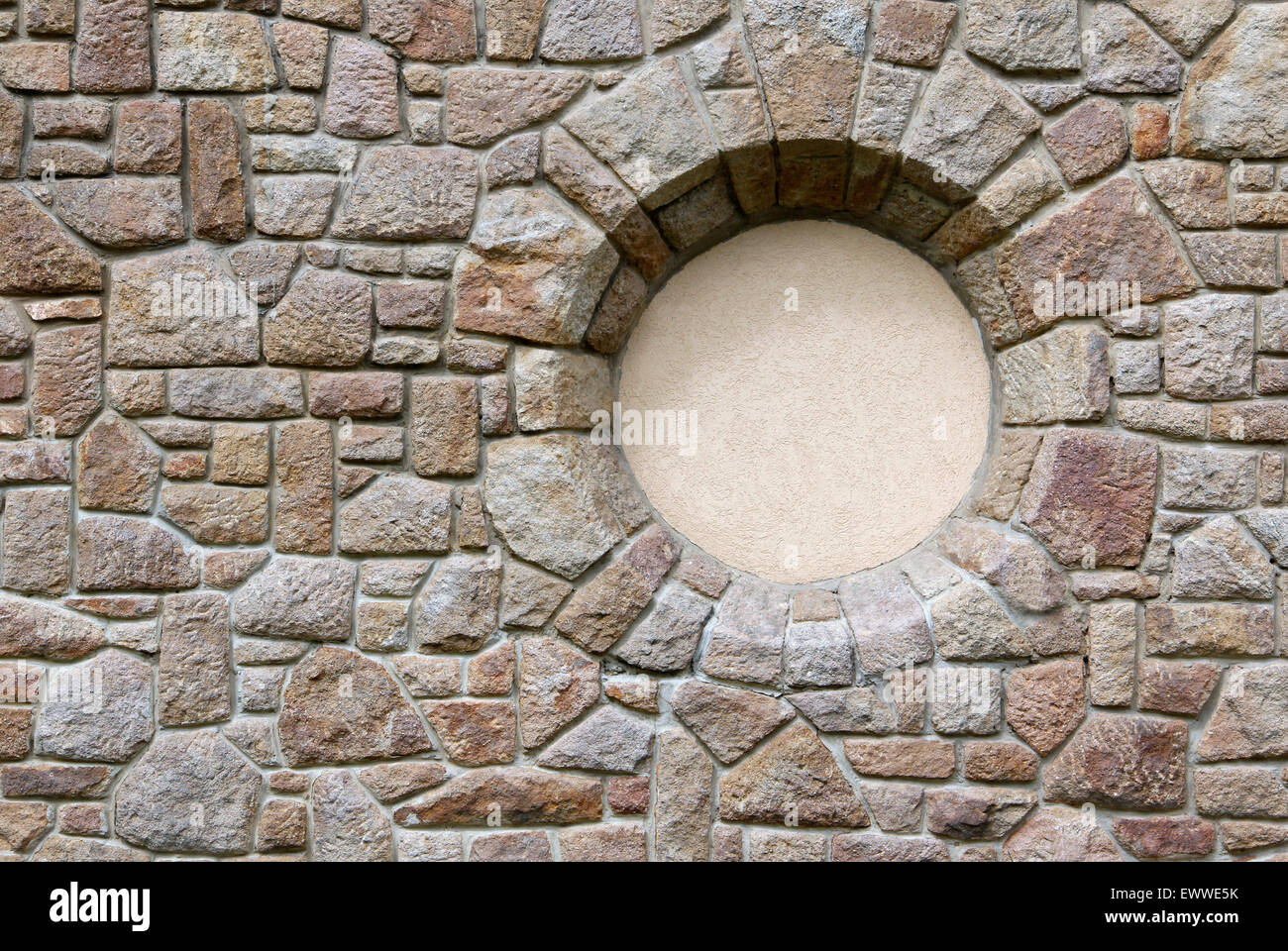 Round window on a stone wall Stock Photo - Alamy