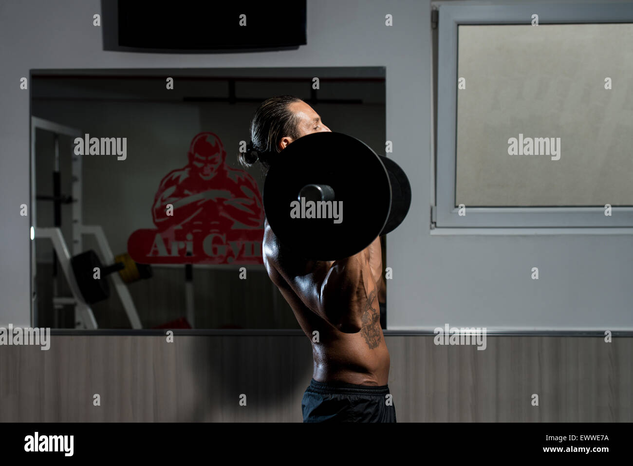 Macho Man Lifting Weights With Barbell Stock Photo - Alamy