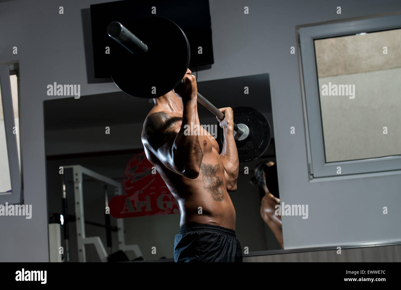 Man Lifting Barbell In Gym Stock Photo - Alamy