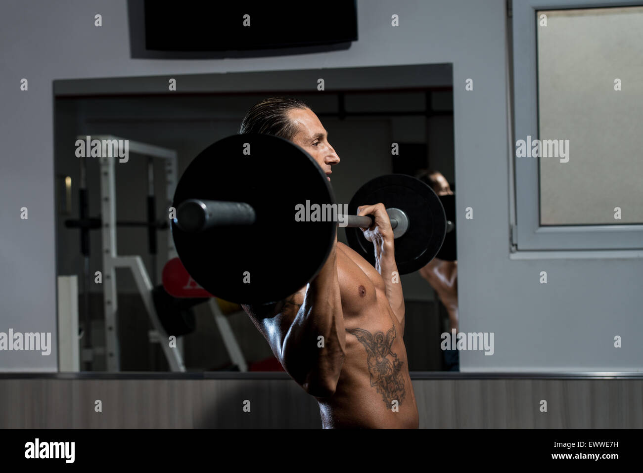 Macho Man Lifting Weights With Barbell Stock Photo - Alamy