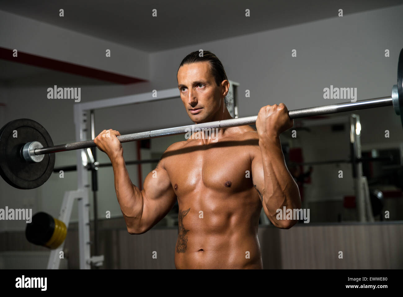 Muscular Man Exercising In Gym Stock Photo - Alamy