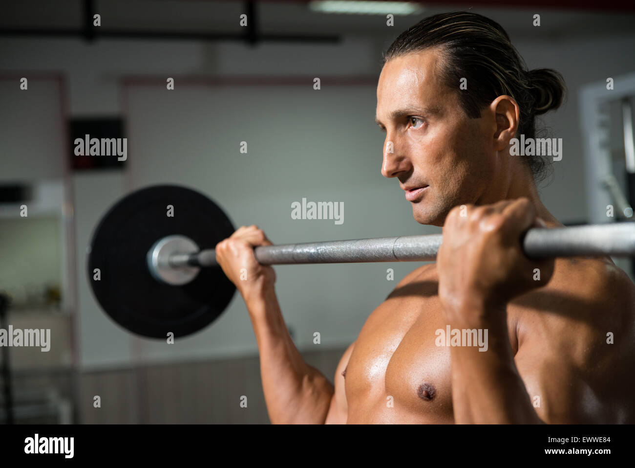 Muscular Man Exercising In Gym Stock Photo - Alamy