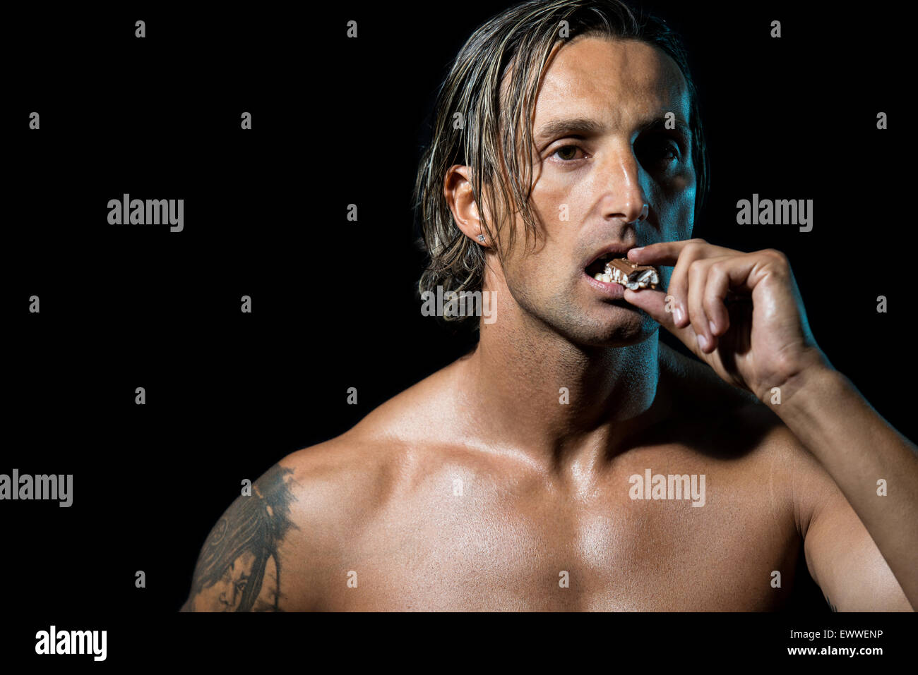 Bodybuilder Eating Chocolate Stock Photo - Alamy