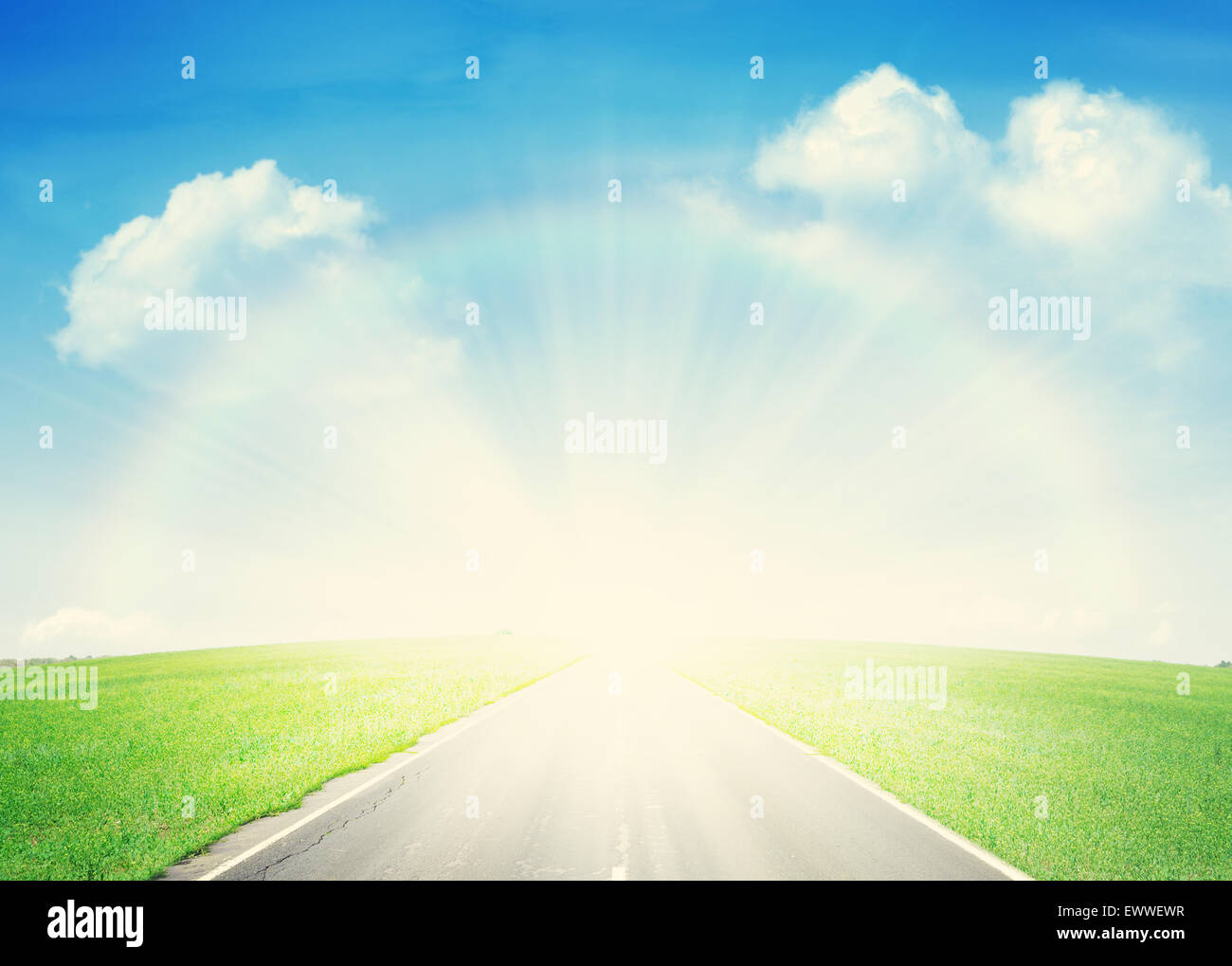 Summer landscape with endless asphalt road through the green field and ...