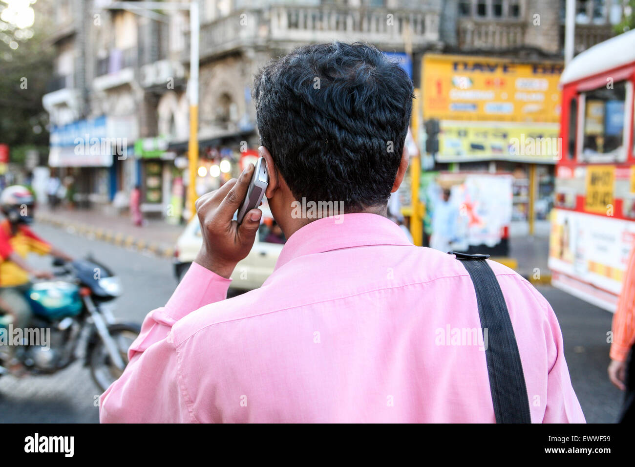 Indian businessman using his mobile phone in centre of Colaba, Mumbai ...