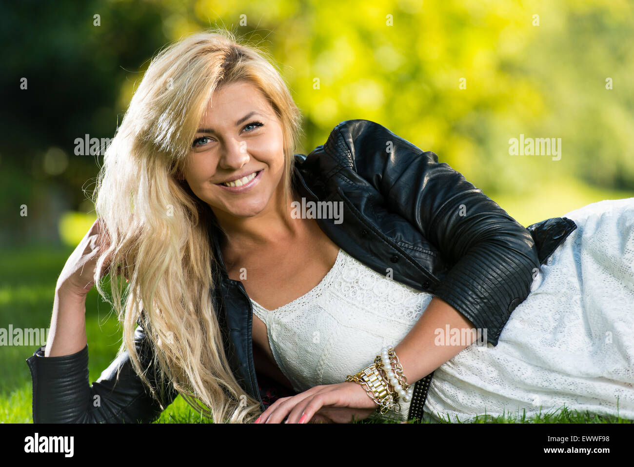Girl Resting In Meadow Stock Photo - Alamy