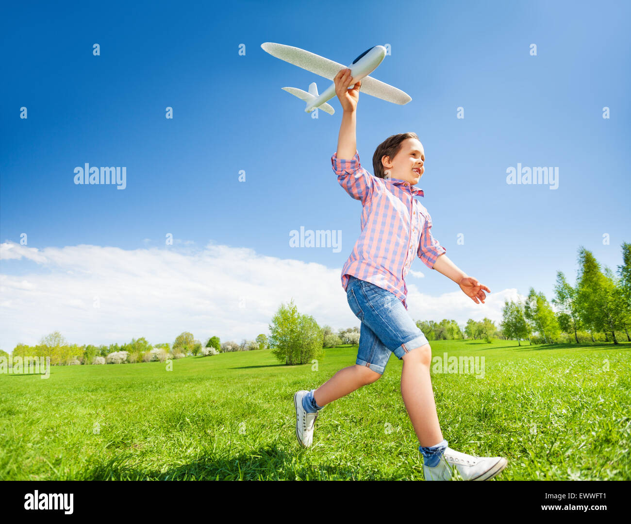 Boy who is holding airplane toy during running Stock Photo - Alamy