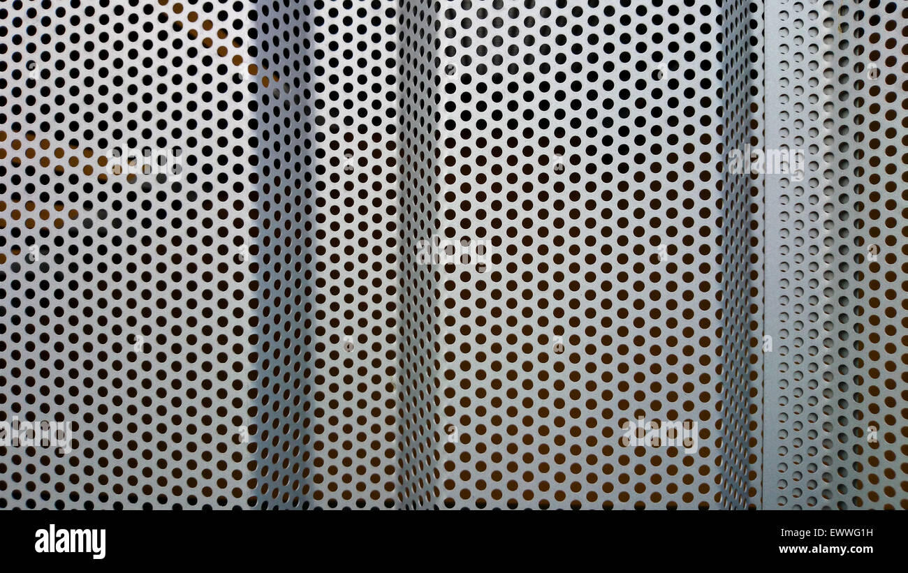 Metal wall profile with round holes as background Stock Photo - Alamy