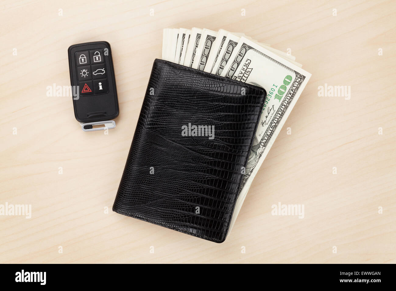 Money cash wallet and car remote key on wooden table Stock Photo - Alamy