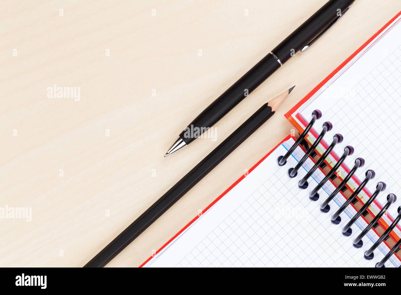 Office table with blank notepad, pen and pencil. View from above with ...
