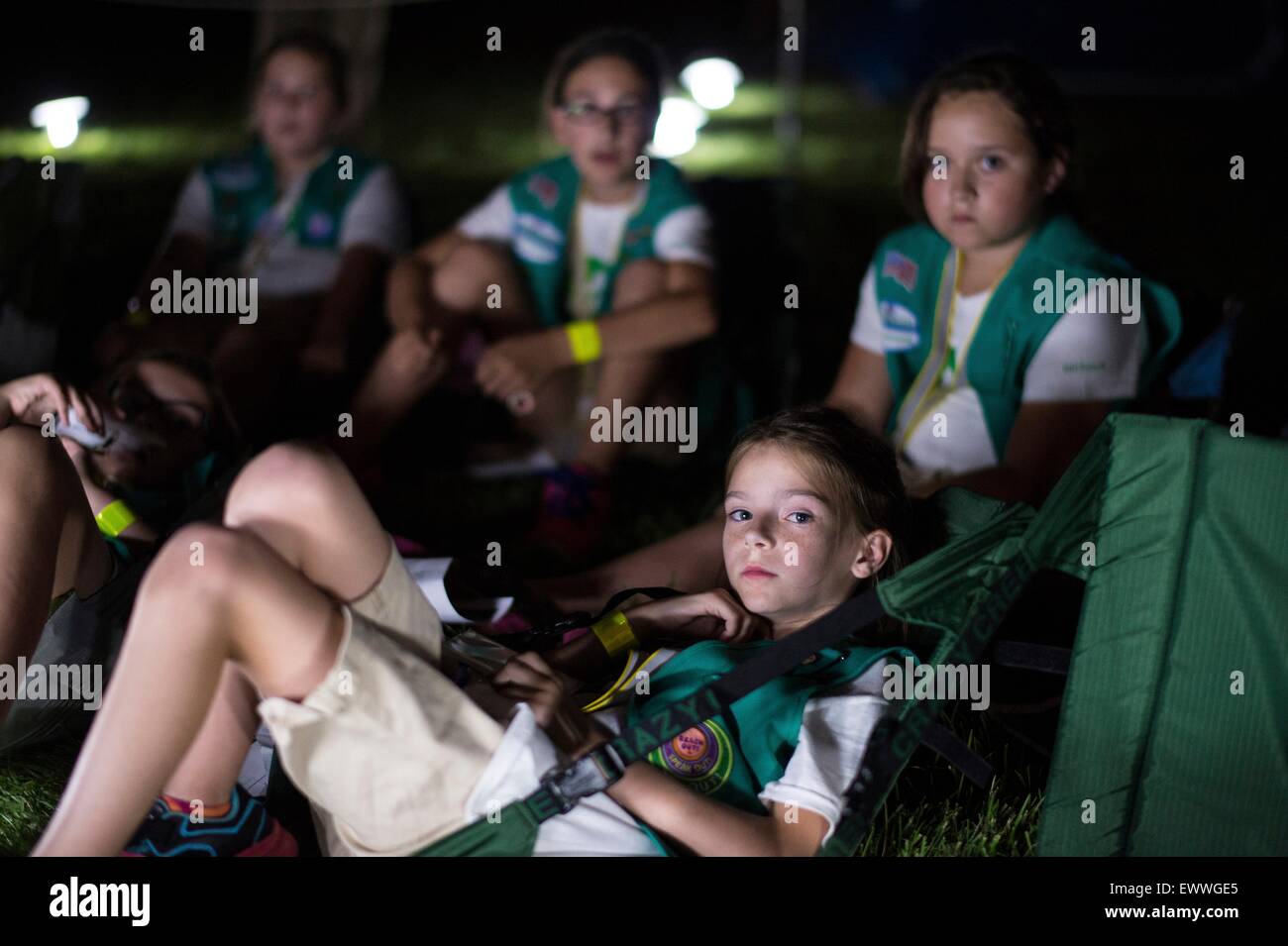 A group Girl Scouts rest around a campfire during the first-ever White ...