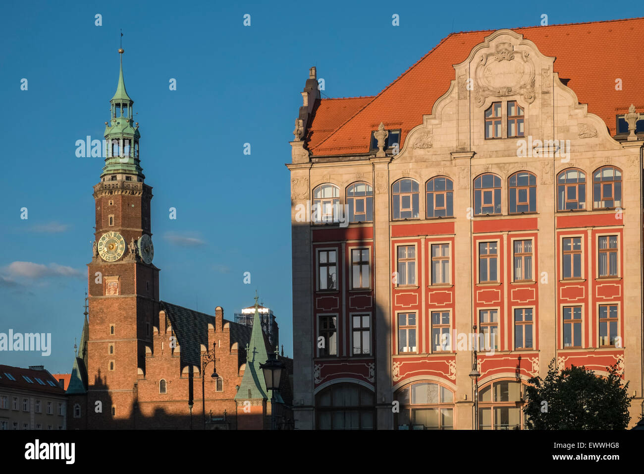 Wroclaw town hall clock tower and adjacent traditional building in early evening light, Wroclaw ...