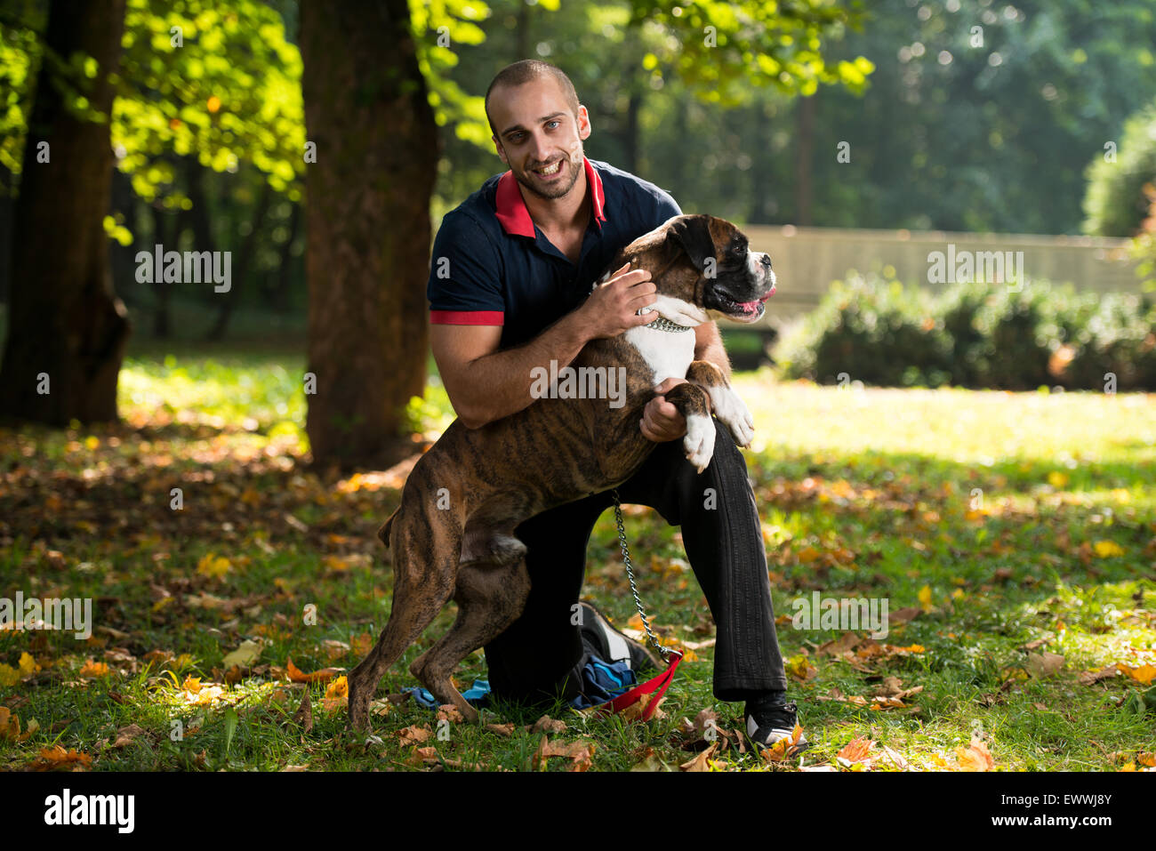 Man Holding Dog Stock Photo - Alamy