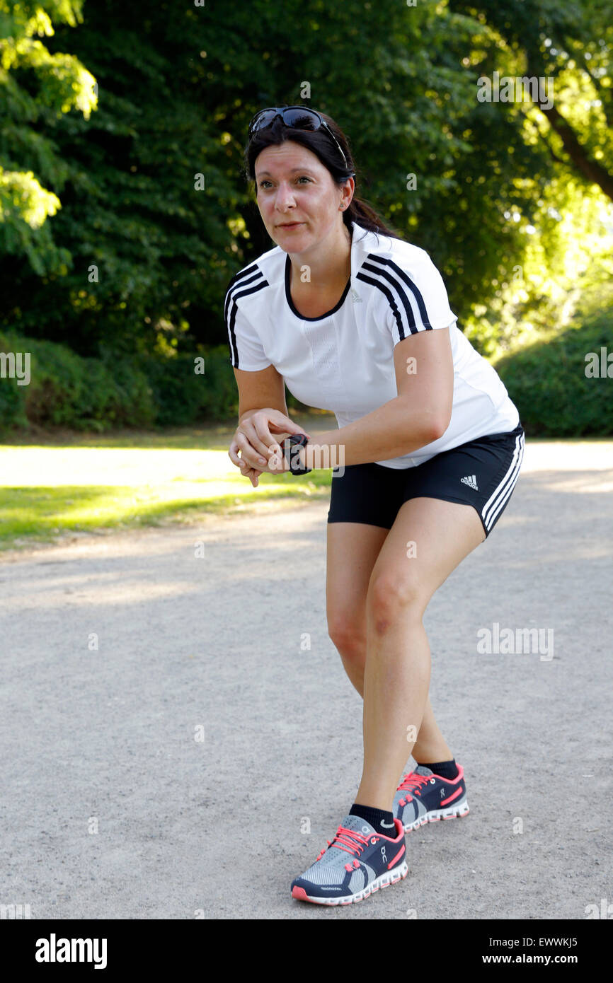 Runner controlling distance, heart rate, burned fat e.c. by a digital ...