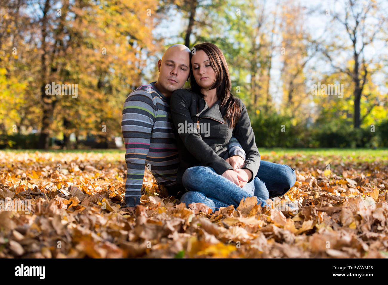 Couple holding yellow leaf hi-res stock photography and images - Alamy