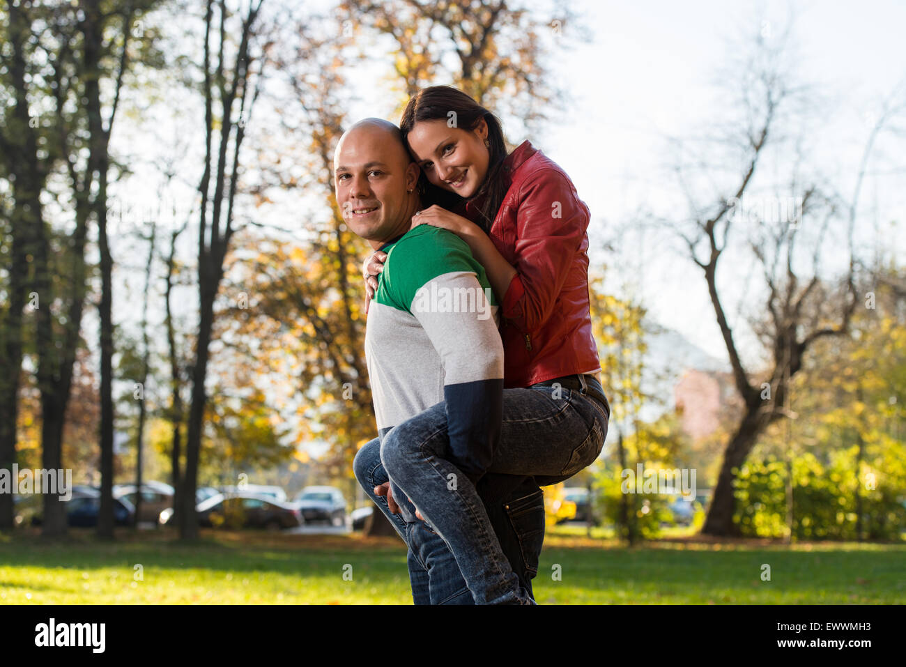 Male Carrying Smiling Female On His Back At Park Stock Photo - Alamy