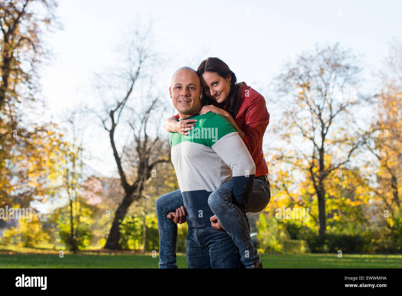 Man Carrying Woman Piggyback At Autumn Woods Stock Photo - Alamy