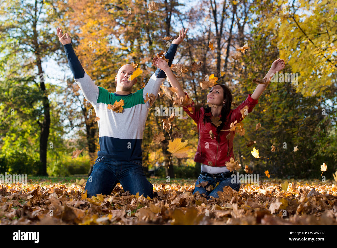 Young Couple Throwing Fall Leaves Stock Photo - Alamy