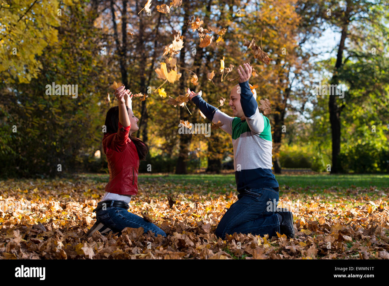 Couple Throwing Leaves In The Air Stock Photo - Alamy