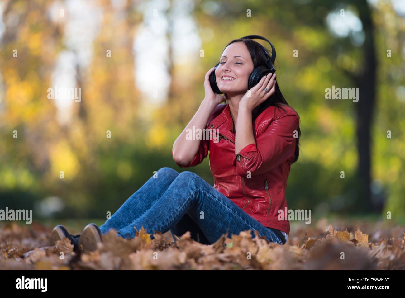 Young Woman Listening To Music In Nature Stock Photo - Alamy
