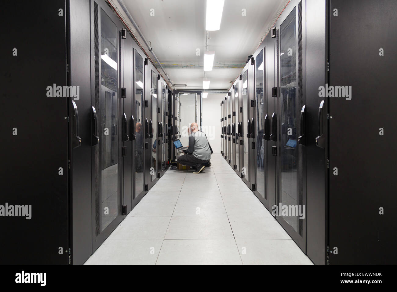 Server specialists working on servers in a server room Stock Photo - Alamy