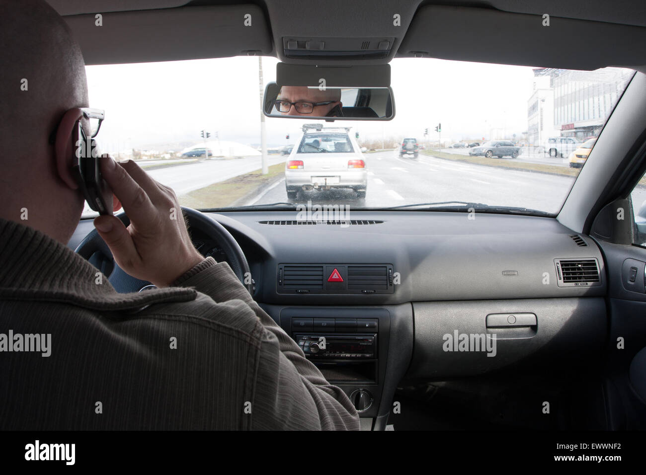 Man on mobile while driving, shot from the backseat Stock Photo - Alamy