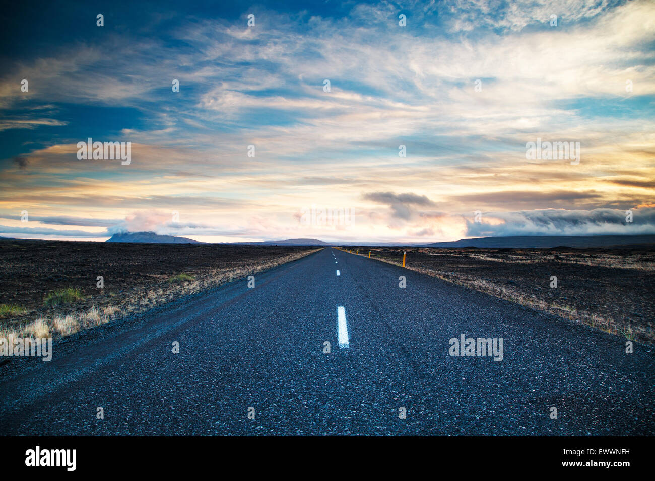 Road leading into the distance under a dramatic sky Stock Photo - Alamy