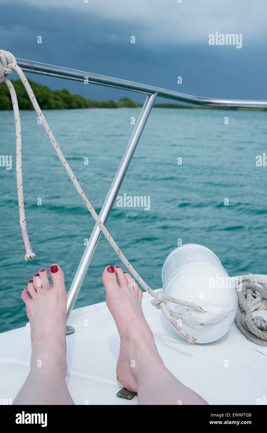 Feet on a boat in Belize Stock Photo - Alamy