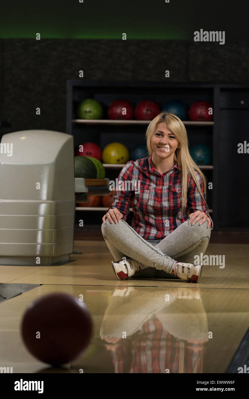 Happy Bowler Sitting At The Bowling Alley Stock Photo - Alamy